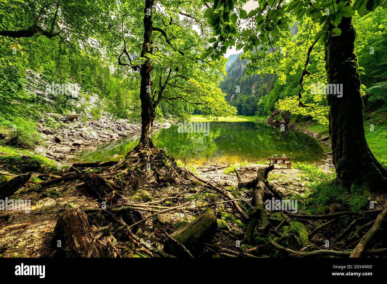 Two kids sitting at the lakeshore of the legendary Lake Kammersee ...