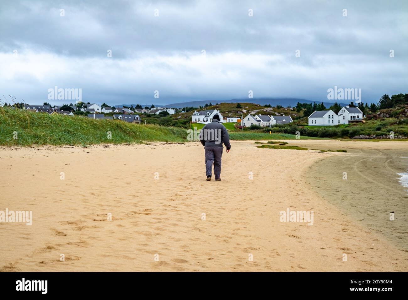 Man walking at Bunbeg beach , Co. Donegal, Ireland Stock Photo - Alamy