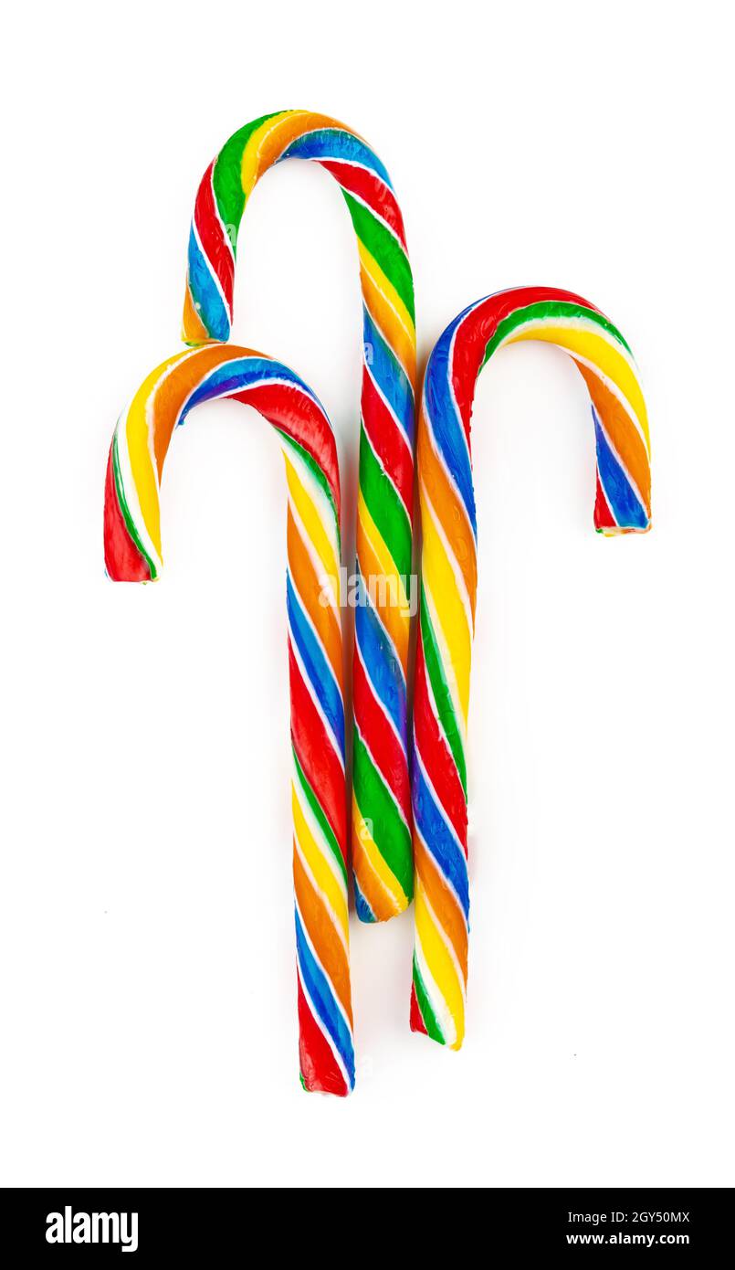 Rainbow colored candy cane isolated on white background Stock Photo - Alamy