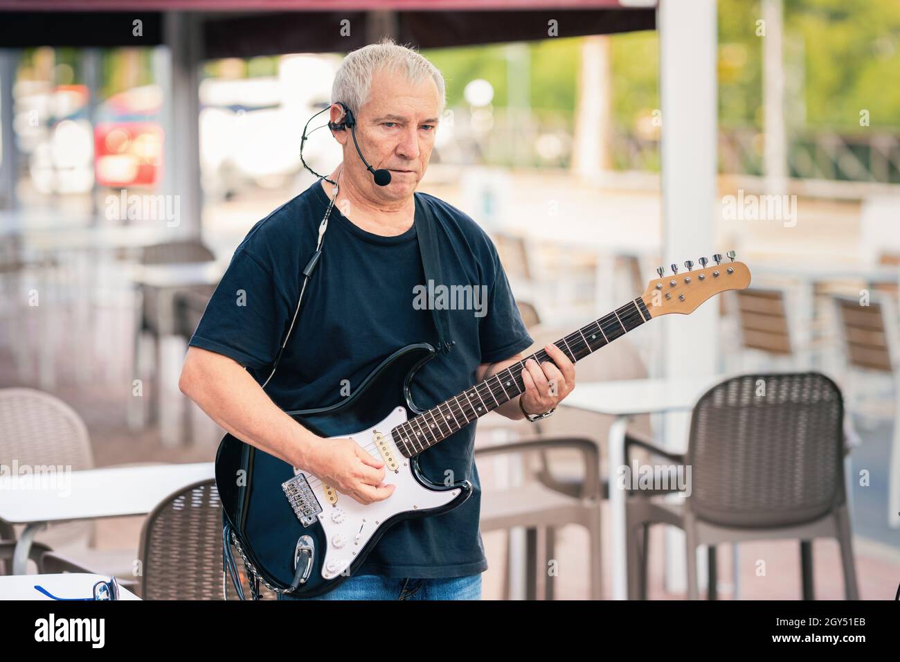 Old musician on the stage performing with an electric guitar Stock ...