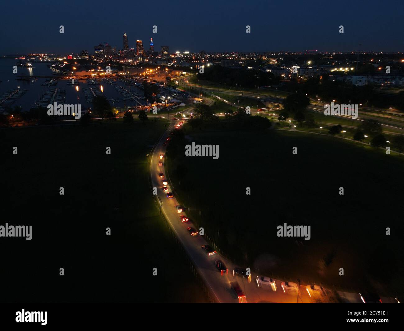 Aerial view of busy highway and buildings with sparkling night lights ...
