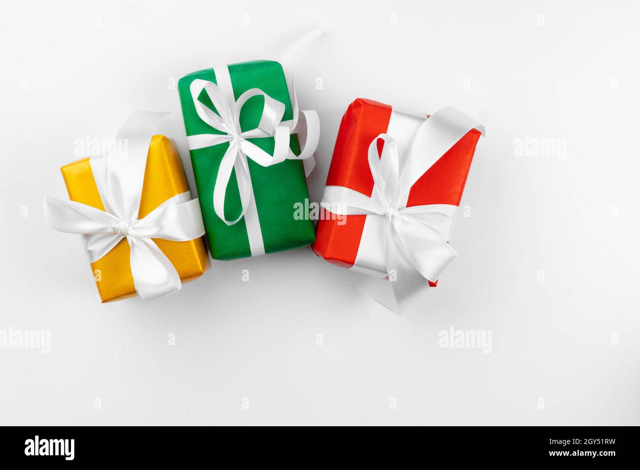 Three beautiful wrapped gifts isolated on white background Stock Photo ...