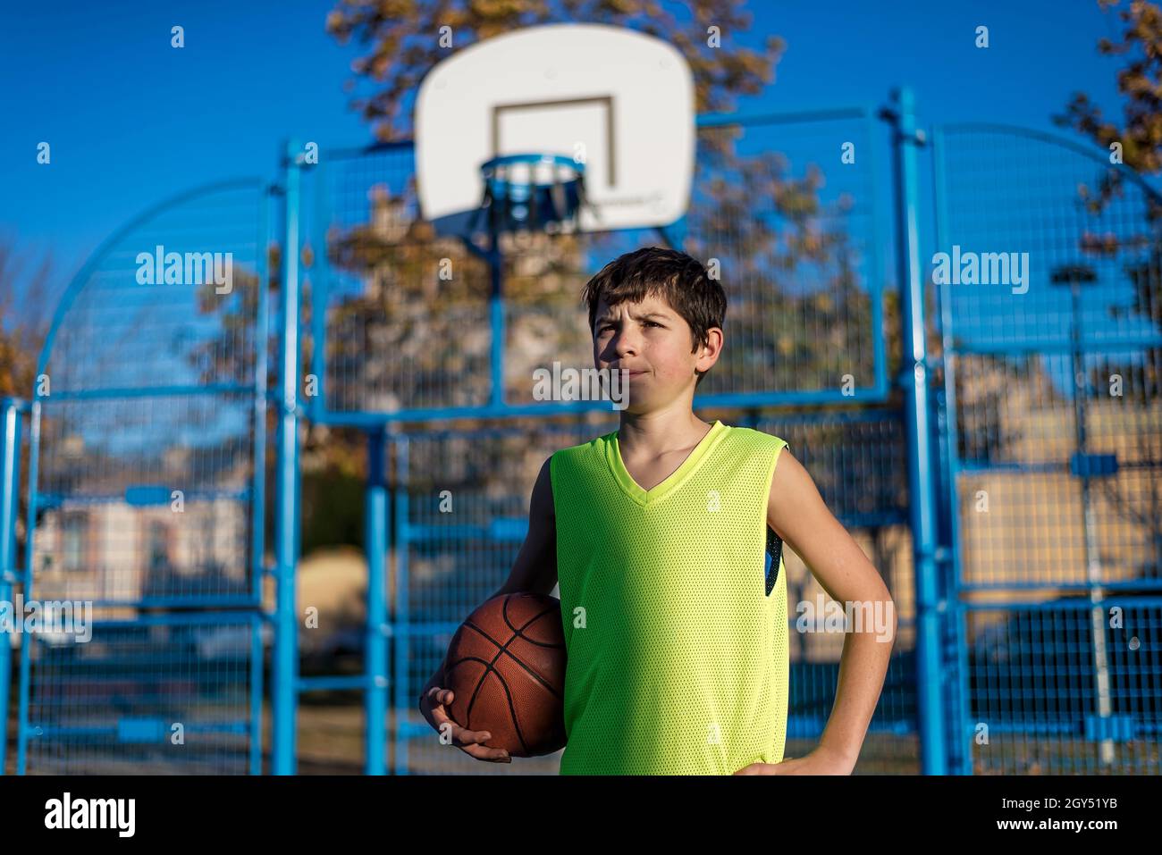 Cool boy holding basketball hi-res stock photography and images - Alamy