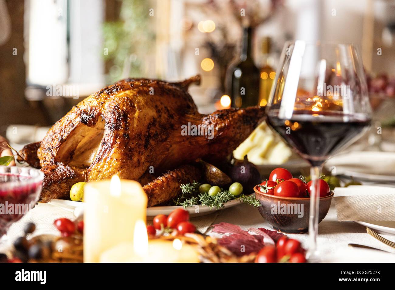 Close-up festive decorated table with roasted turkey and holiday ...