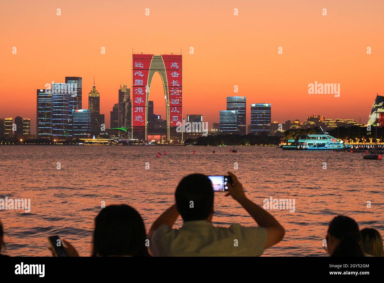 Suzhou, China. 02nd Oct, 2021. A man takes photos at Suzhou Jinji lake ...