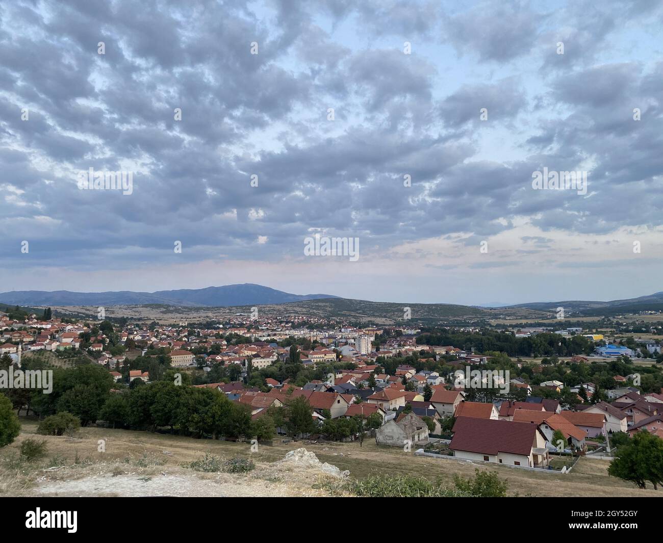 Landscape of a town under a cloudy sky on a gloomy day Stock Photo - Alamy