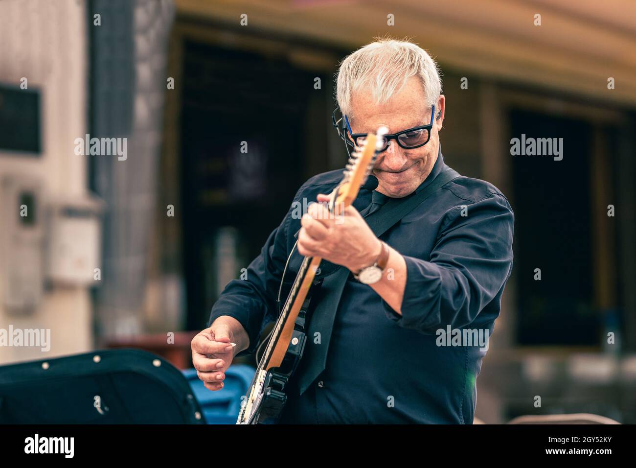 Musician playing the electric guitar on the stage with energetic ...