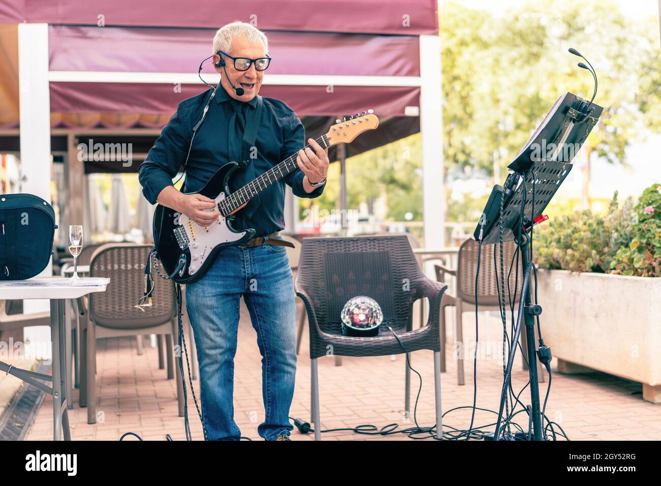 Aged happy musician performing in the terrace of a restaurant Stock ...