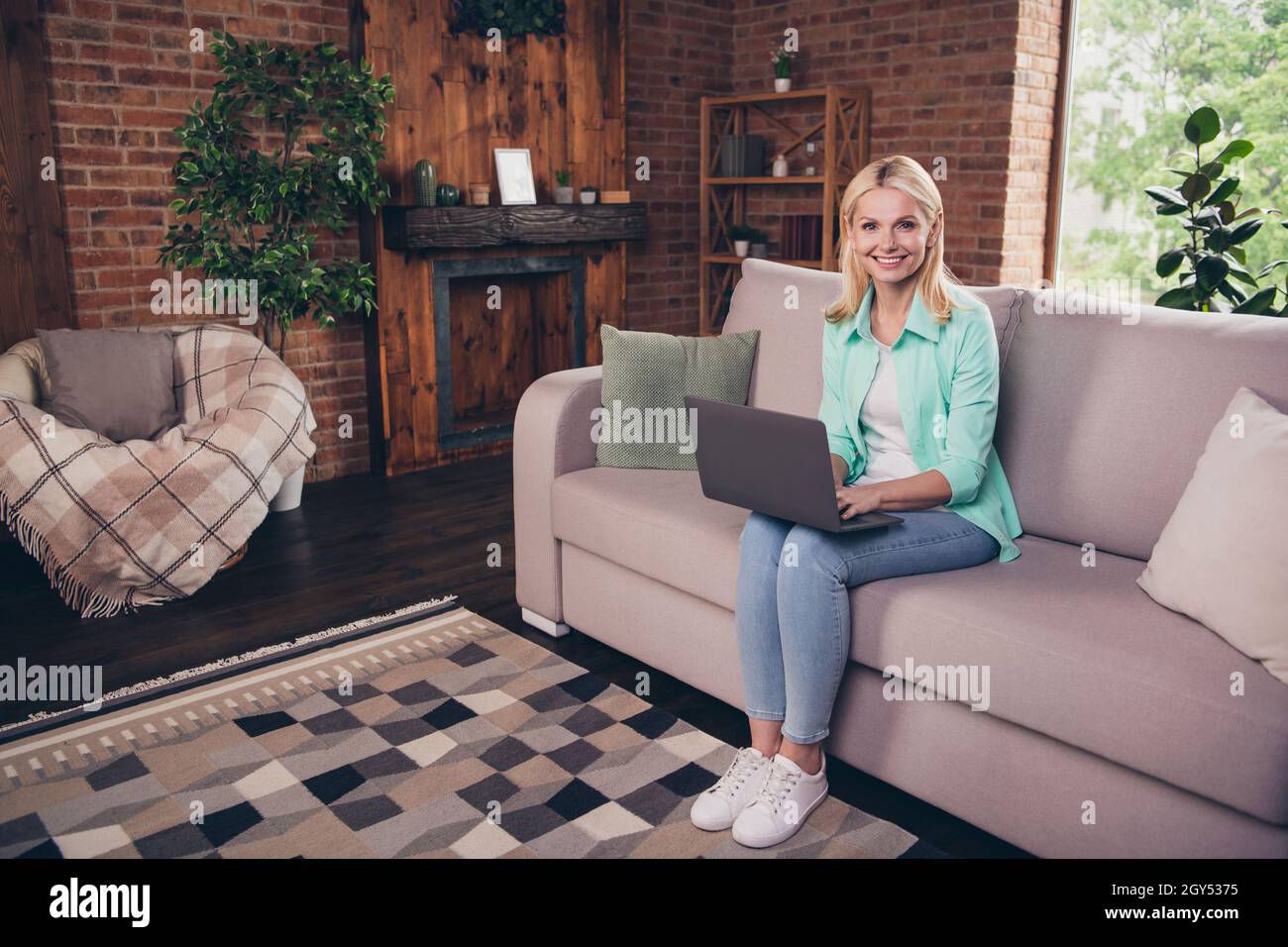 Full length body size photo woman smiling using laptop typing message ...