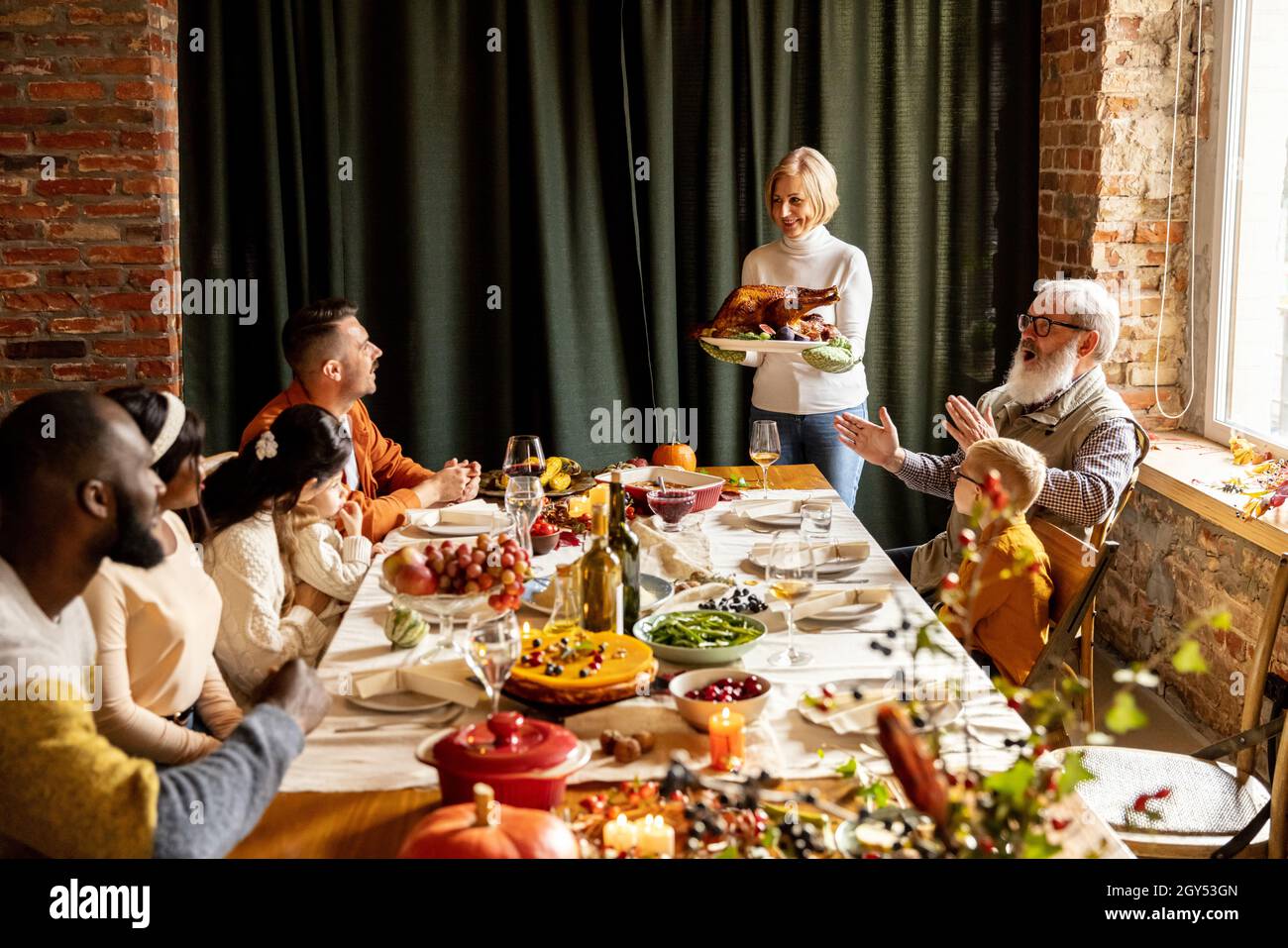 Happy Thanksgiving dinner party with family and friends with turkey and ...