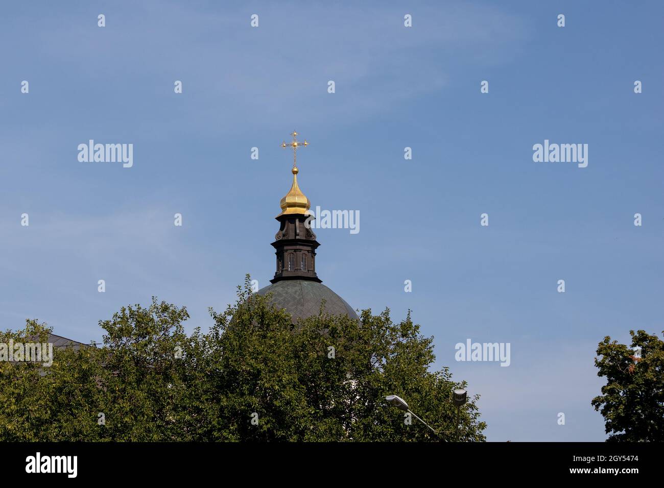 Close up shot of the top view of the golden cross of the church in ...