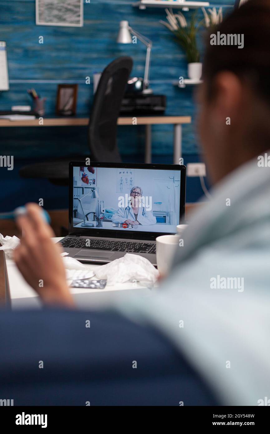 Woman on computer webcam consultation with doctor sitting at home ...
