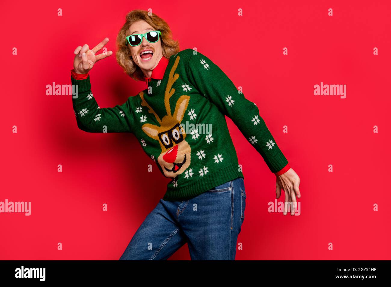 Portrait of attractive funky cheerful guy dancing having fun showing v ...