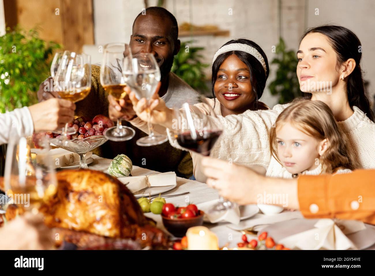 Happy family celebrate Thanksgiving day, sitting at table with roasted ...