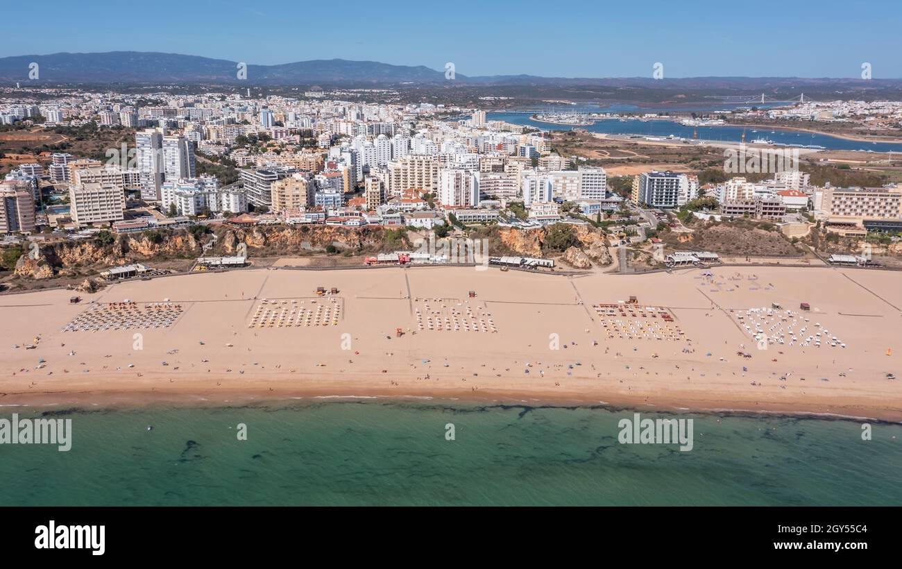 Aerial view of the wide and crowded Portuguese famous Rocha beach in ...