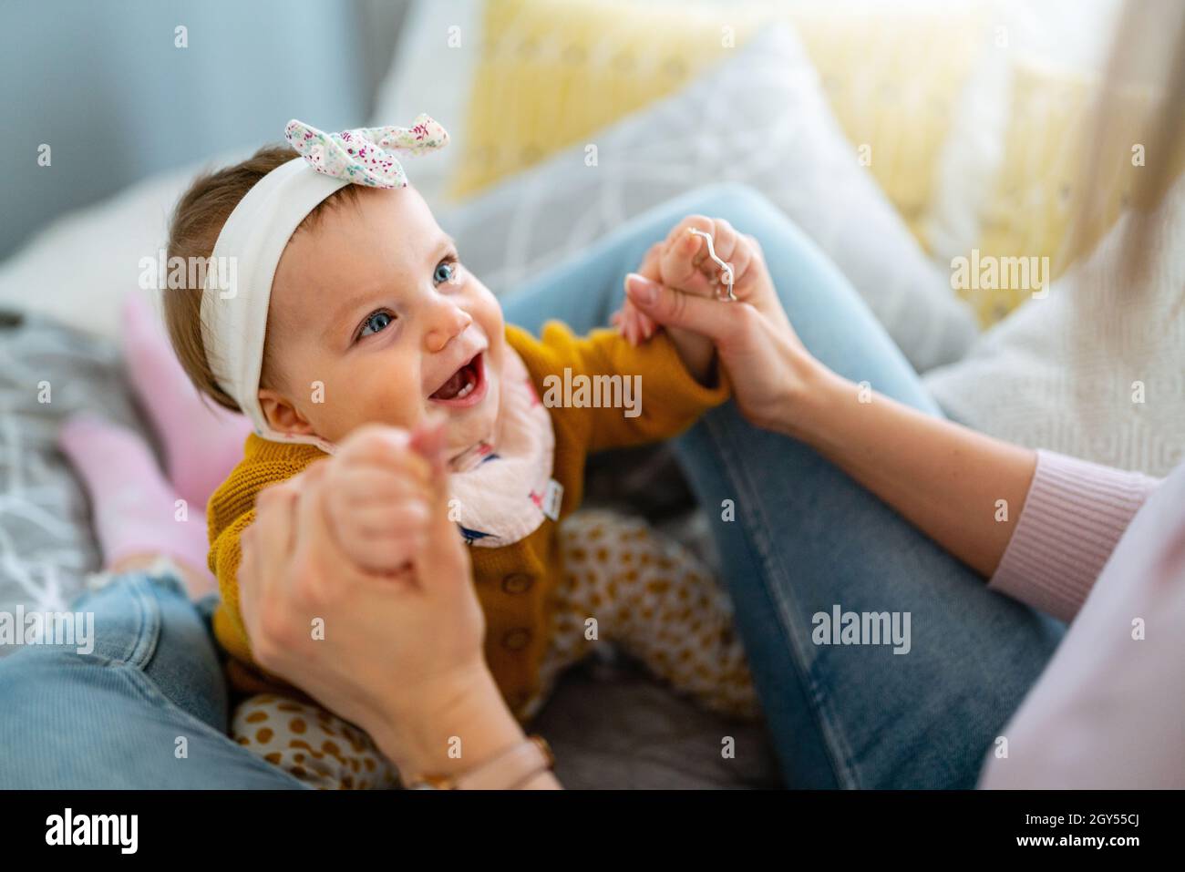 Mother and baby daughter plays, hugging, kissing at home. Happy family ...