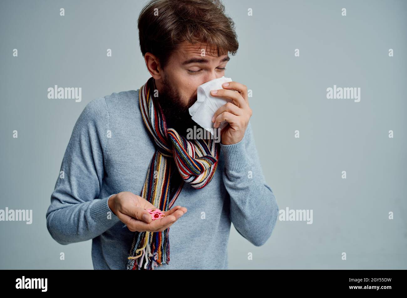bearded man with a scarf around his neck flu health problems light ...
