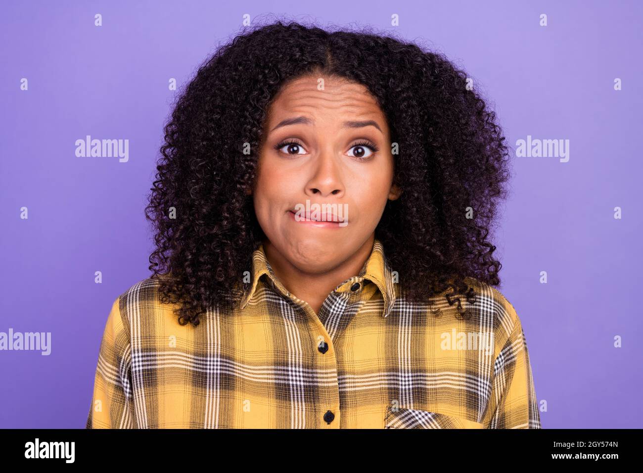 Photo of worried unhappy upset dark skin woman bite lips teeth bad mood ...