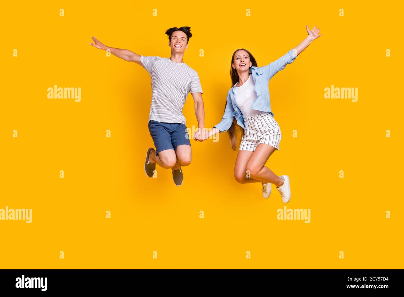 Full length body size view of attractive cheerful couple jumping having ...