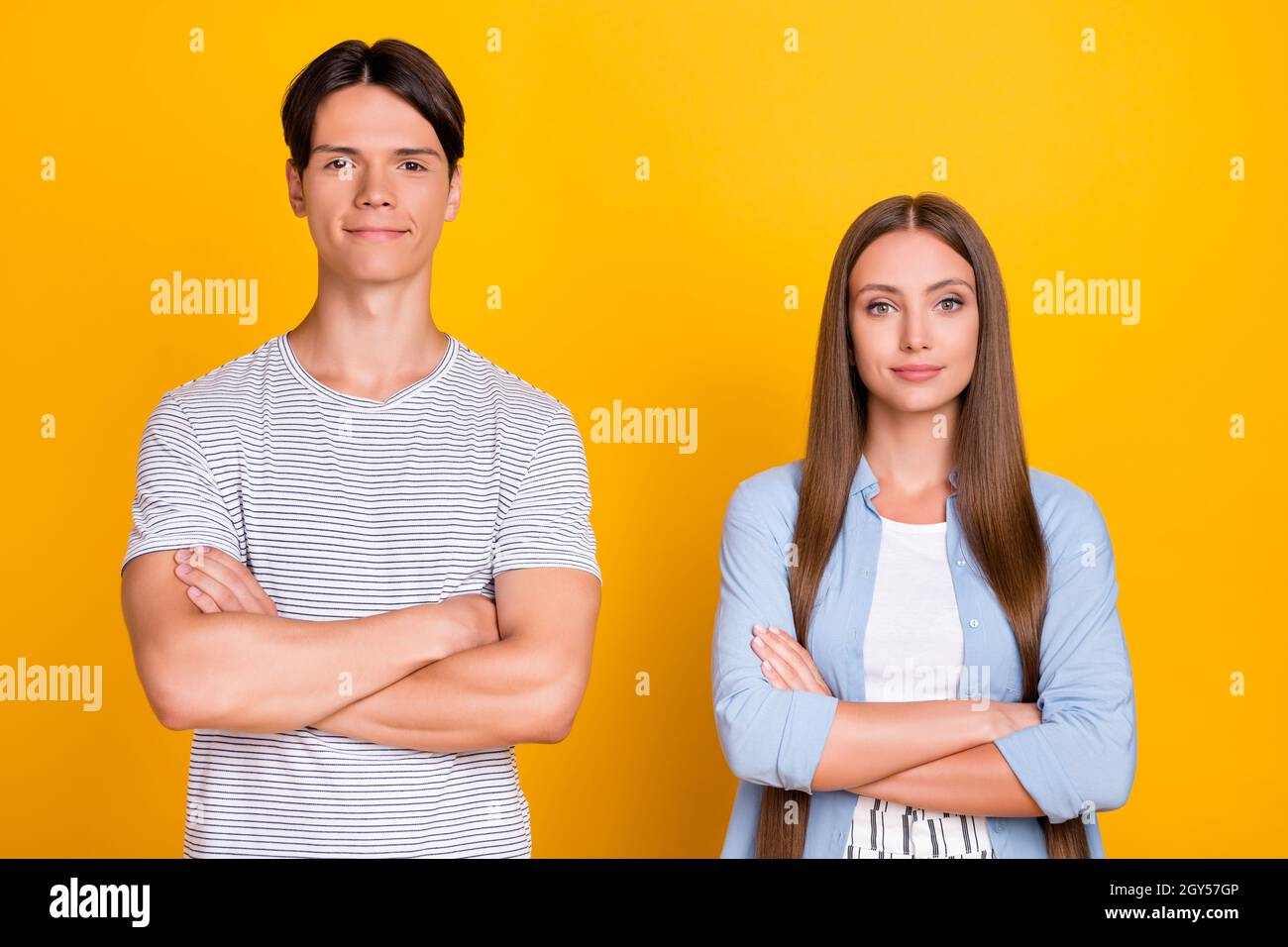 Portrait of attractive content cheery couple partners coworkers folded ...