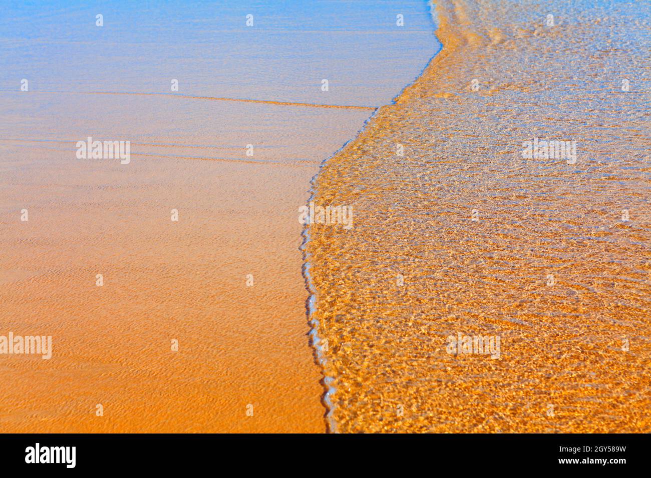 Ocean waves edge on the sand . Transparent water on the sandy beach ...
