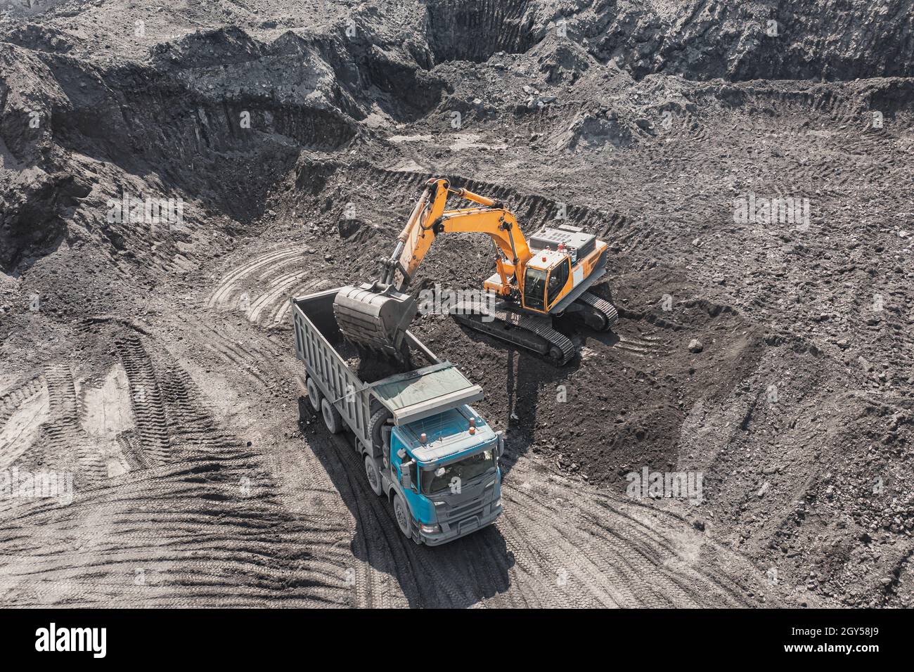 Large quarry dump truck. Loading the rock in dumper. Loading coal into body truck. Production ...