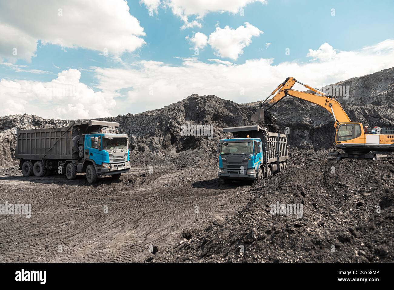 Large quarry dump truck. Loading the rock in dumper. Loading coal into ...