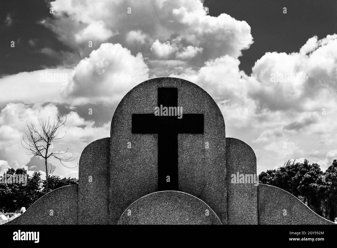 Grayscale of a gravestone with a cross in a cemetery Stock Photo - Alamy