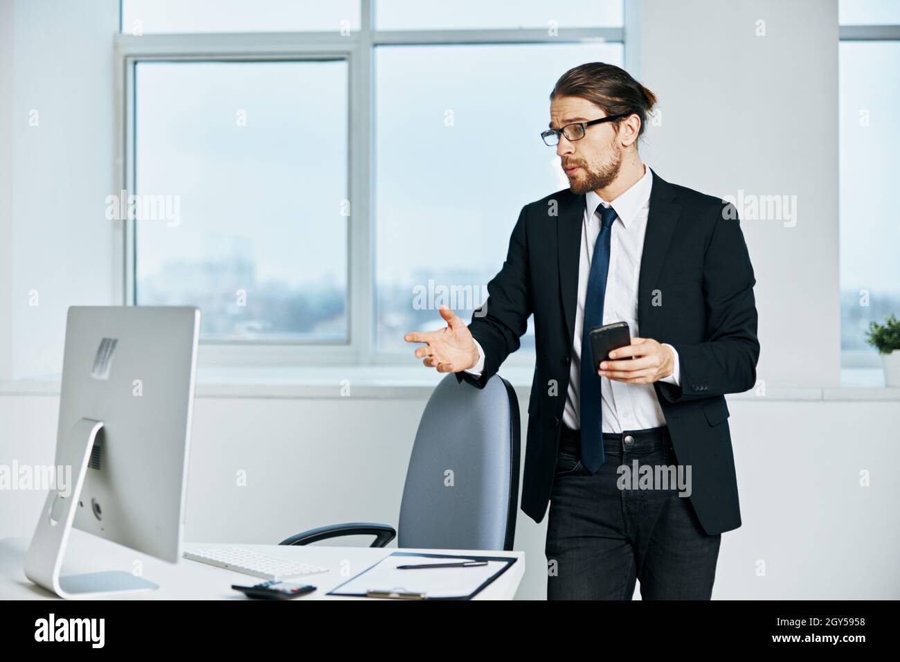 male manager in a suit office work phone technologies Stock Photo - Alamy