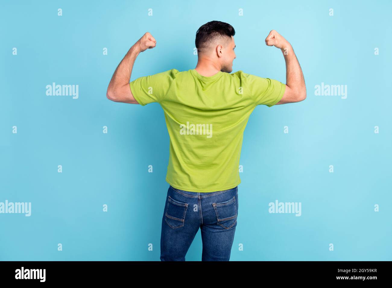 Back rear spine view photo of young happy man show muscles hands ...