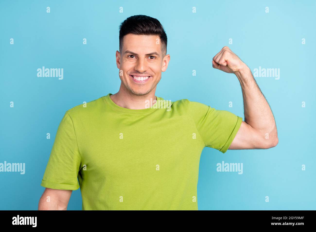 Photo of positive happy cheerful man flex muscles biceps good mood ...