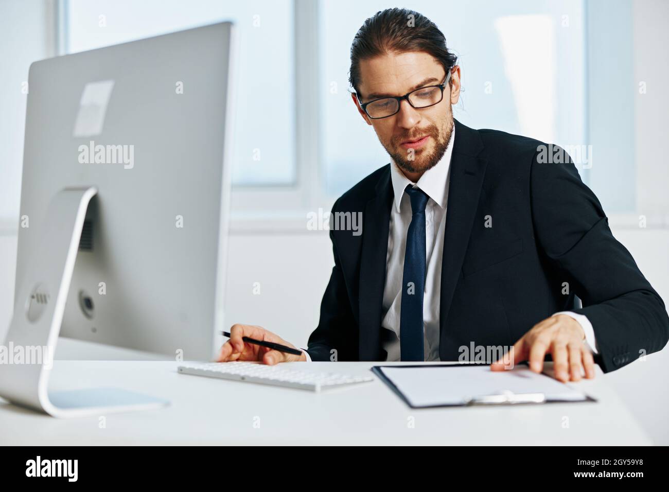 male manager an official is working at the computer Chief Stock Photo ...