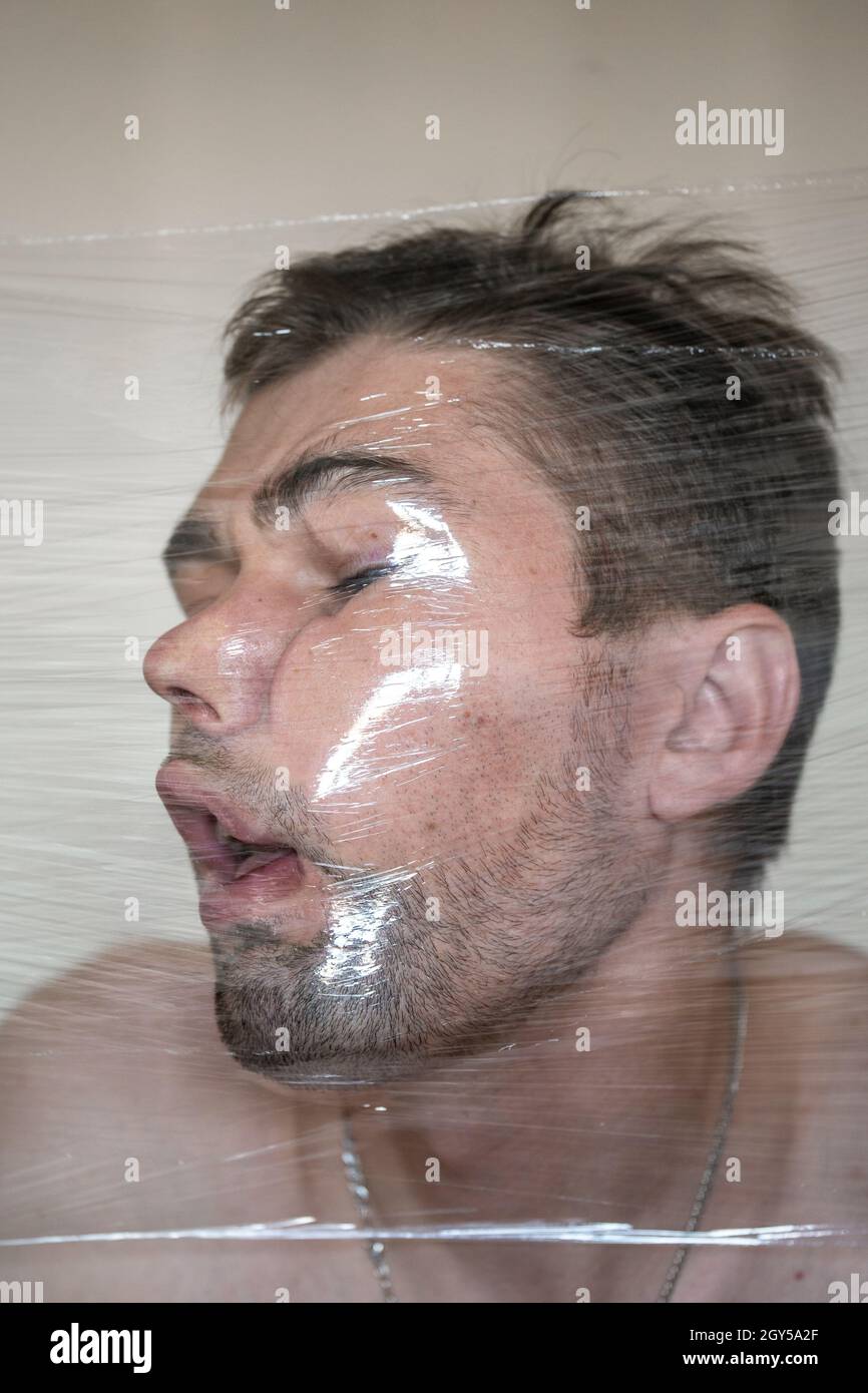 a man's face in a bag. distorted portrait through film Stock Photo - Alamy