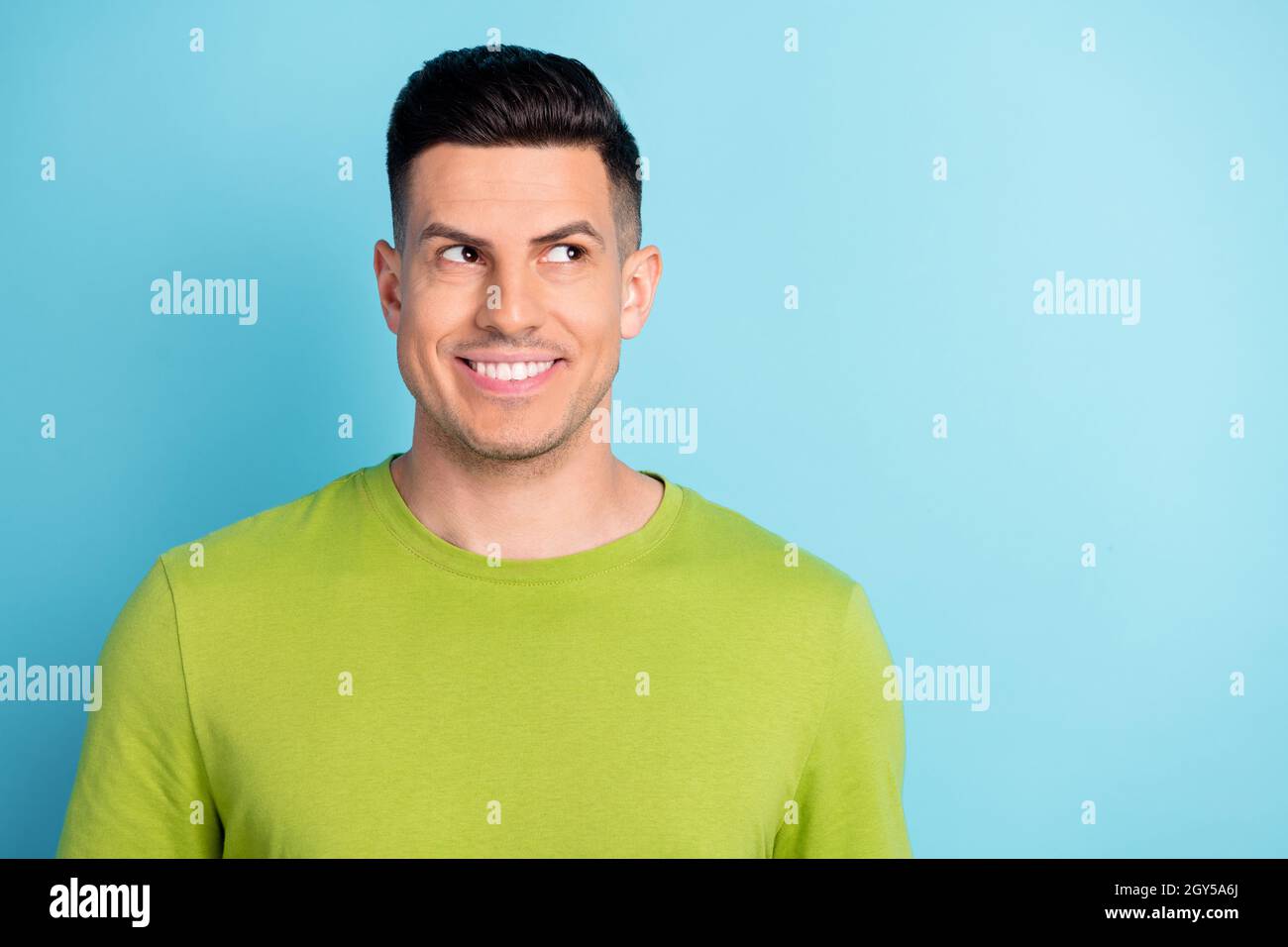 Photo of young cheerful dreamy man look empty space imagine good mood ...