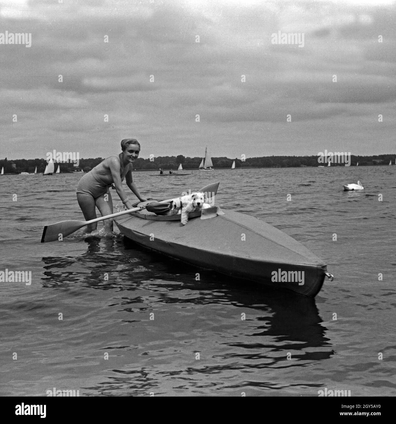 Werbefoto für das Klepper Faltboot: eine junge Frau padelt mit einem ...