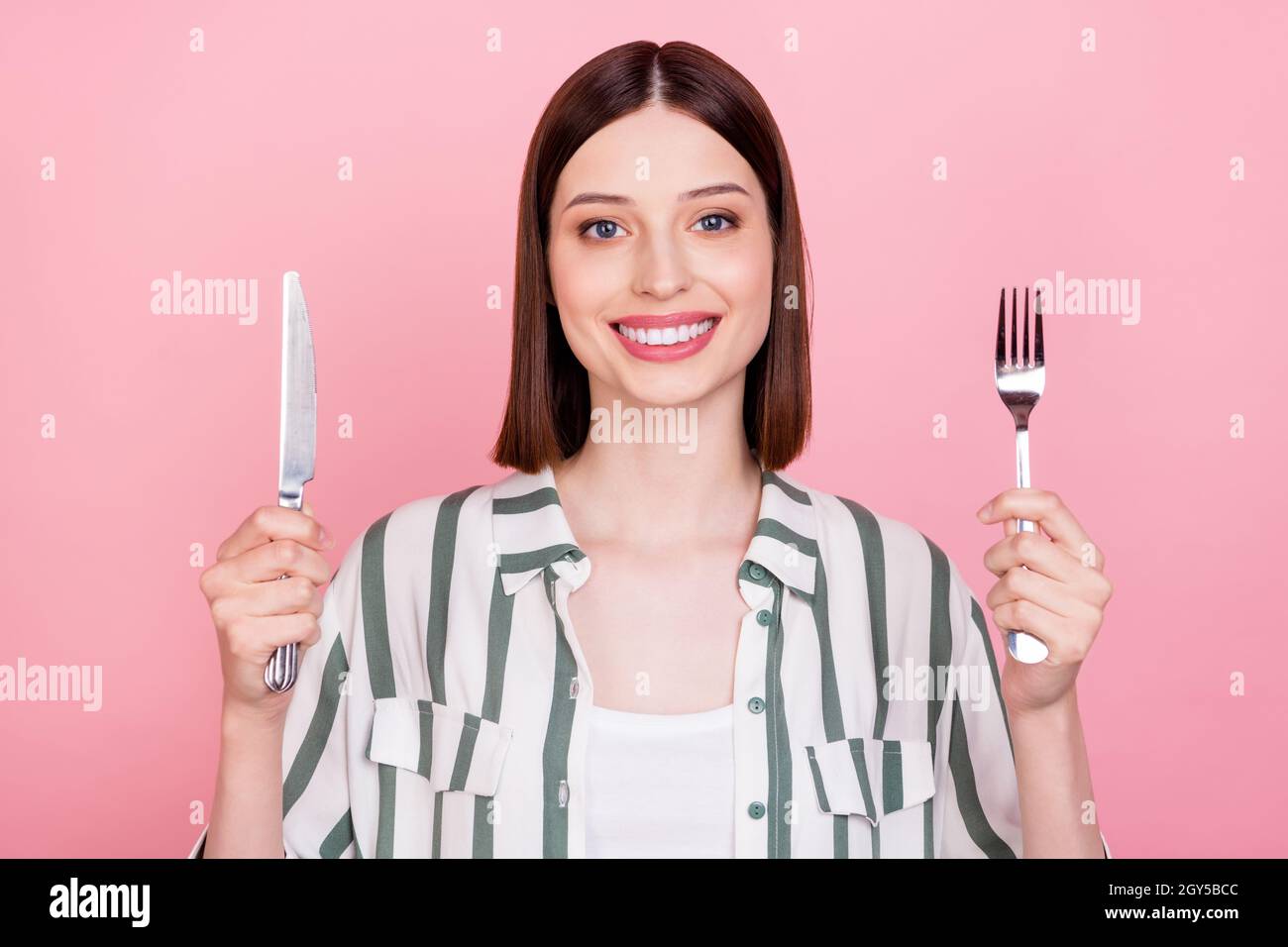Photo Of Nice Brunette Millennial Lady Hold Fork Knife Wear White Shirt