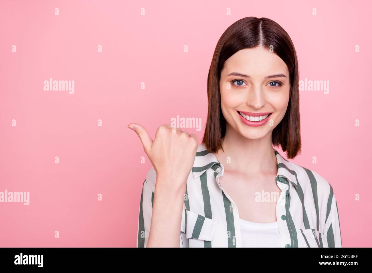 Photo of funky brunette young lady point empty space wear white shirt ...