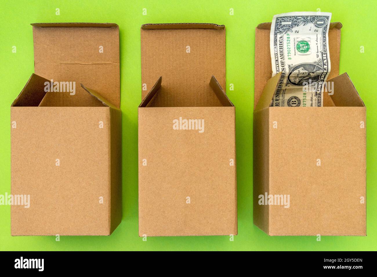 Three open boxes and dollar bulging out of one of them. Financial ...