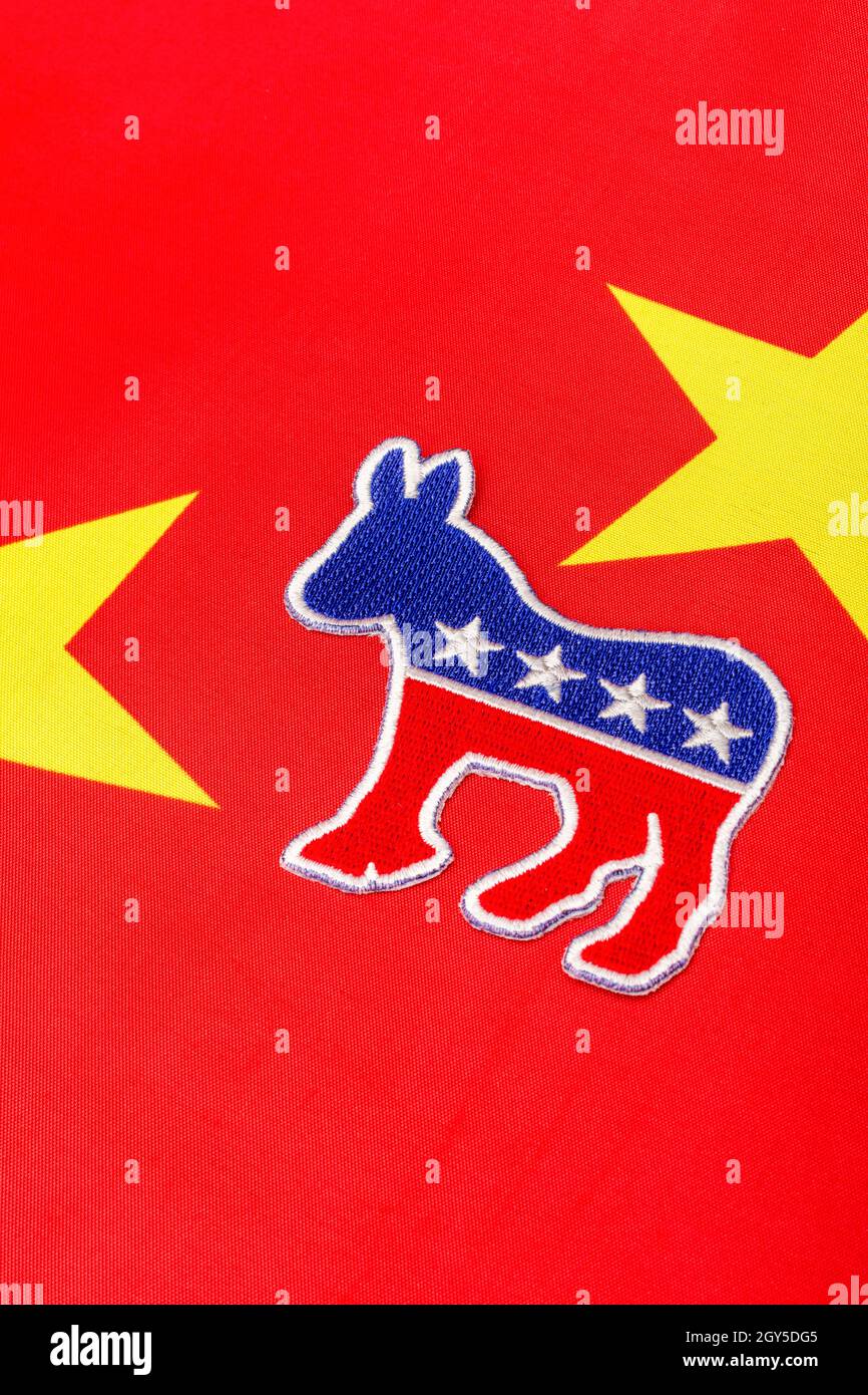 Dems / Democrat donkey logo set against a polyester red Chinese flag ...