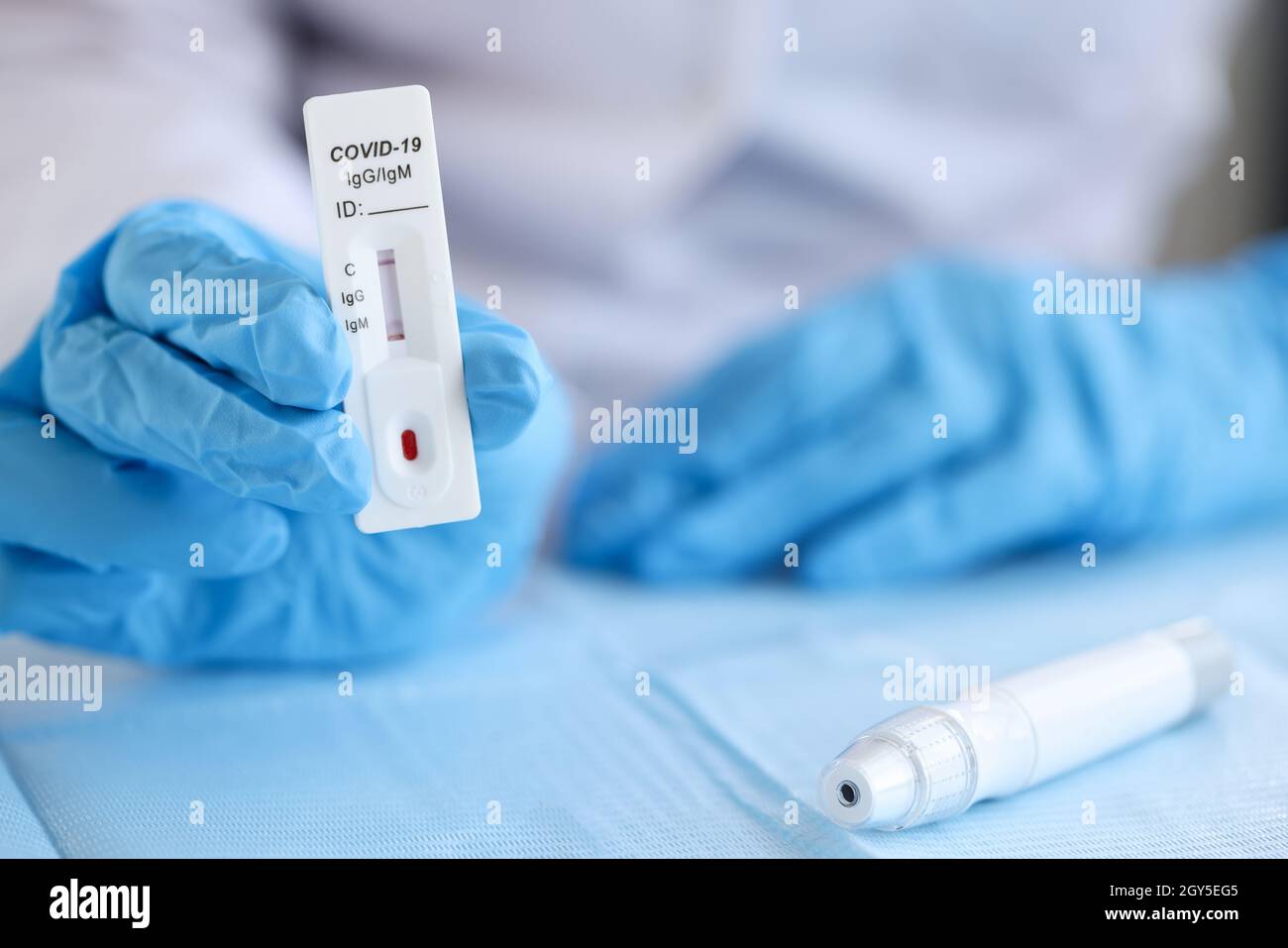 Doctor wearing disposable gloves holds positive PCR test for ...