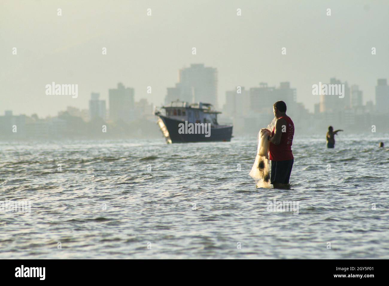 RIO DE JANEIRO, BRAZIL - Sep 10, 2021: A fisherman throwing the net on ...