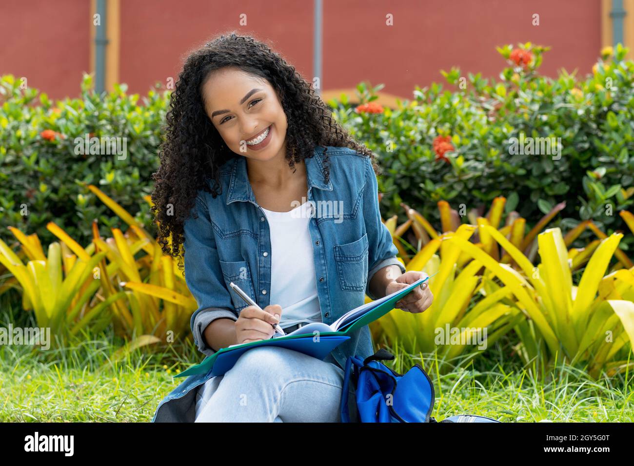 Beautiful brazilian female student with dental aligner learning at ...