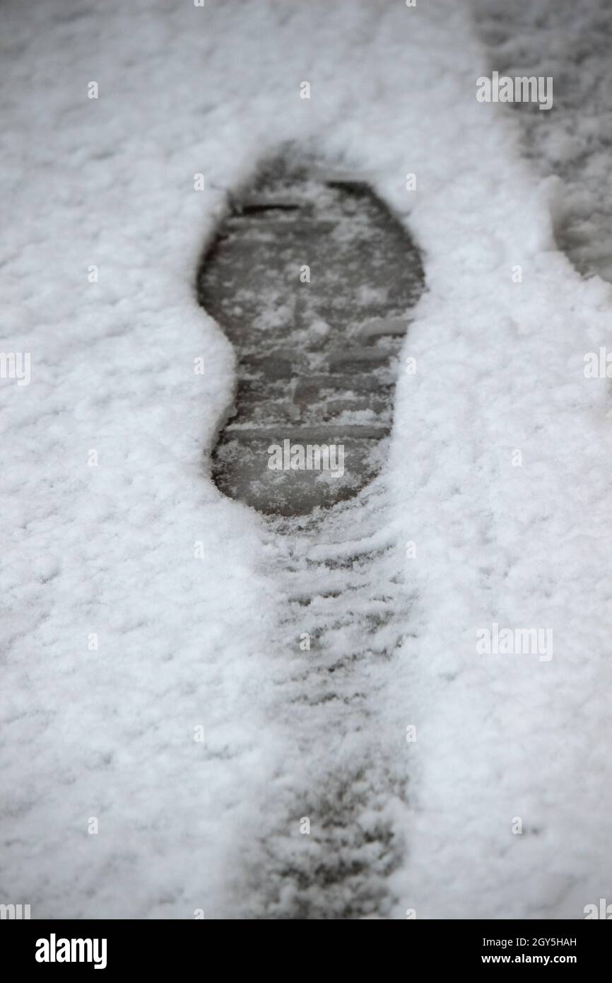 Big footprint on the white snow surface Stock Photo - Alamy