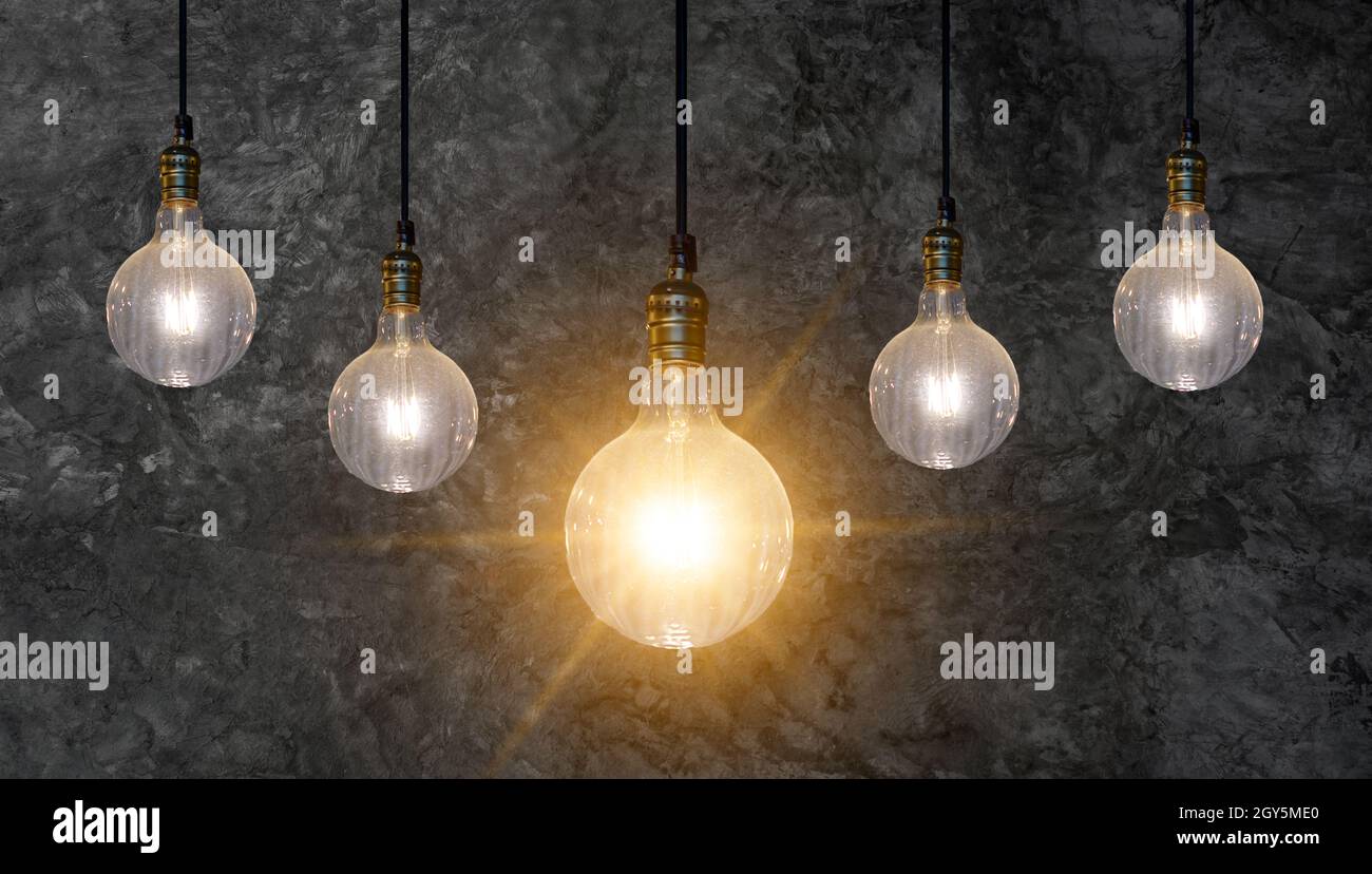 different Light bulb idea Many bulbs are arranged in a row and one of ...
