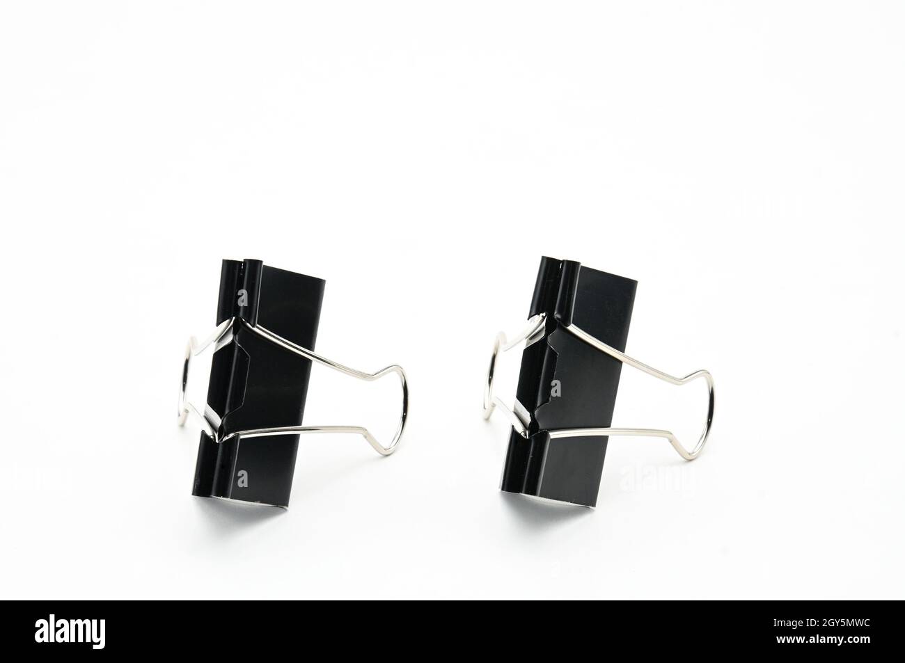 Binder clip device for tying paper sheets together Stock Photo - Alamy