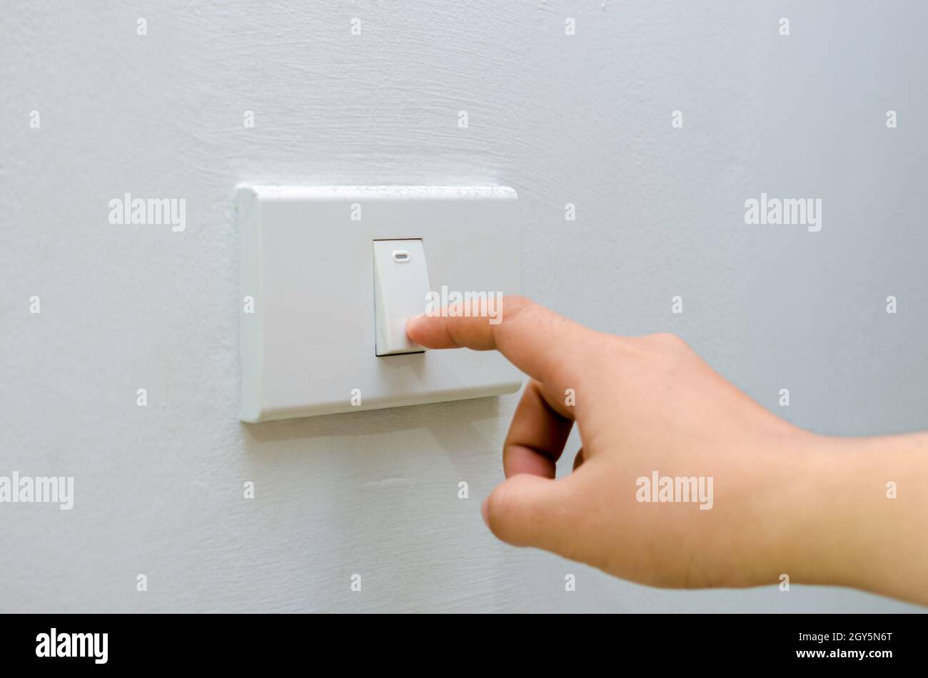 Save electricity Close up of finger is turning on or off on light ...