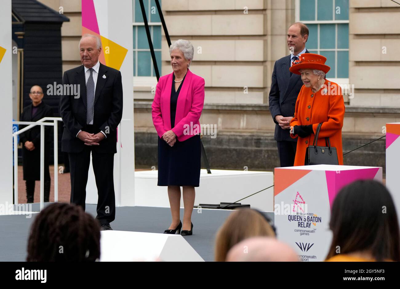 Queen Elizabeth II, watches as the Queen's Baton first relay runner ...