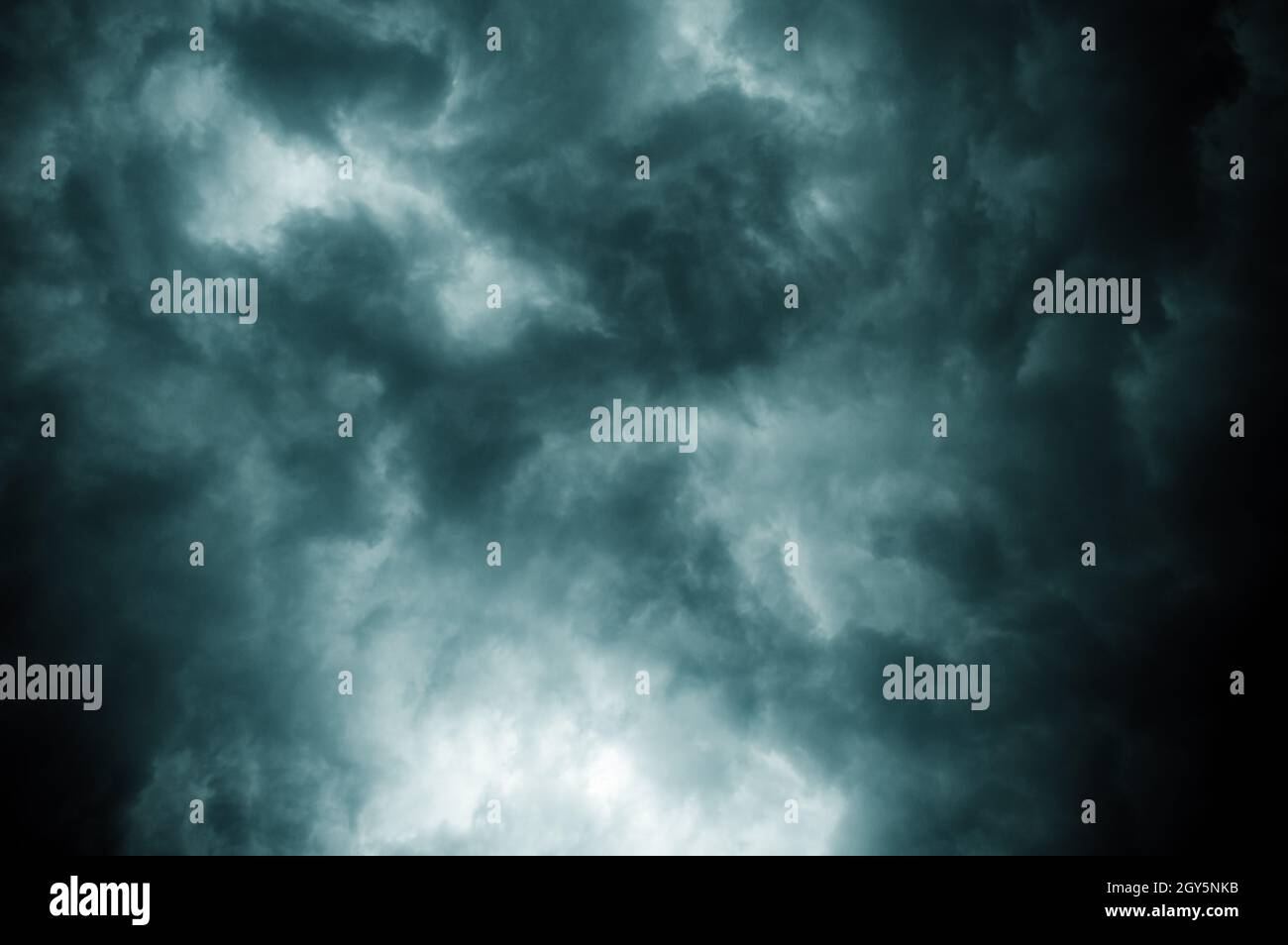 Thick dark black storm clouds covering summer sunset sky with gale ...