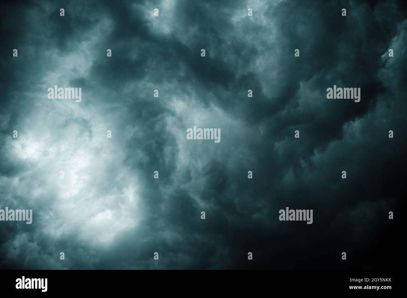 Thick dark black storm clouds covering summer sunset sky with gale ...