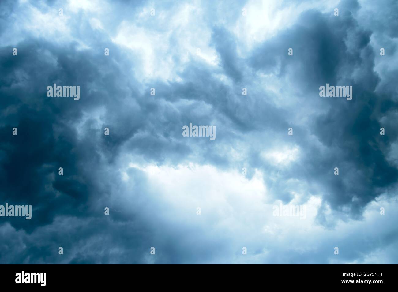 Thick dark black storm clouds covering summer sunset sky with gale ...